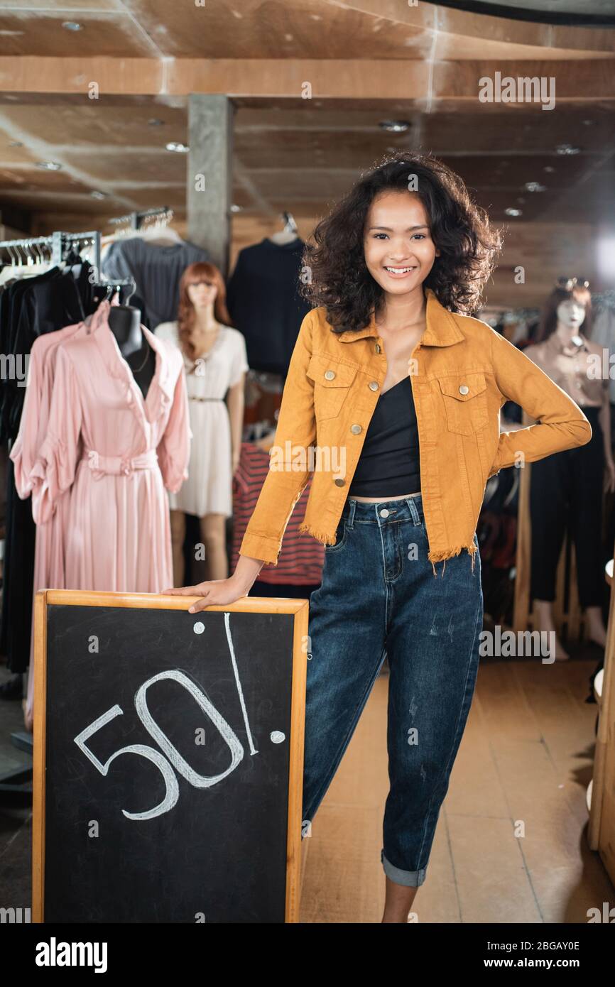 beautiful shop owner holding blackboard with discount Stock Photo - Alamy