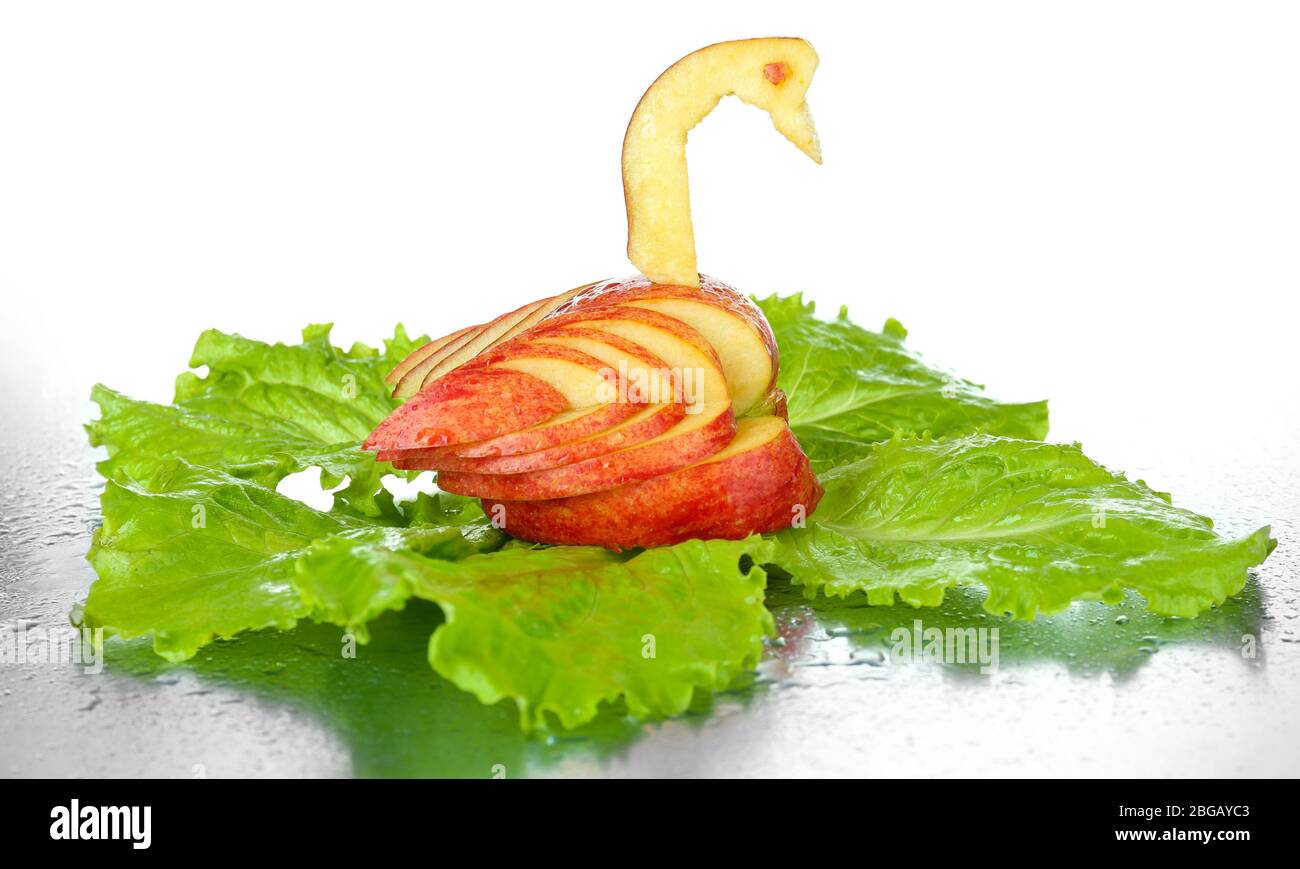 Carving fruit pattern of swan on grey wet background Stock Photo - Alamy