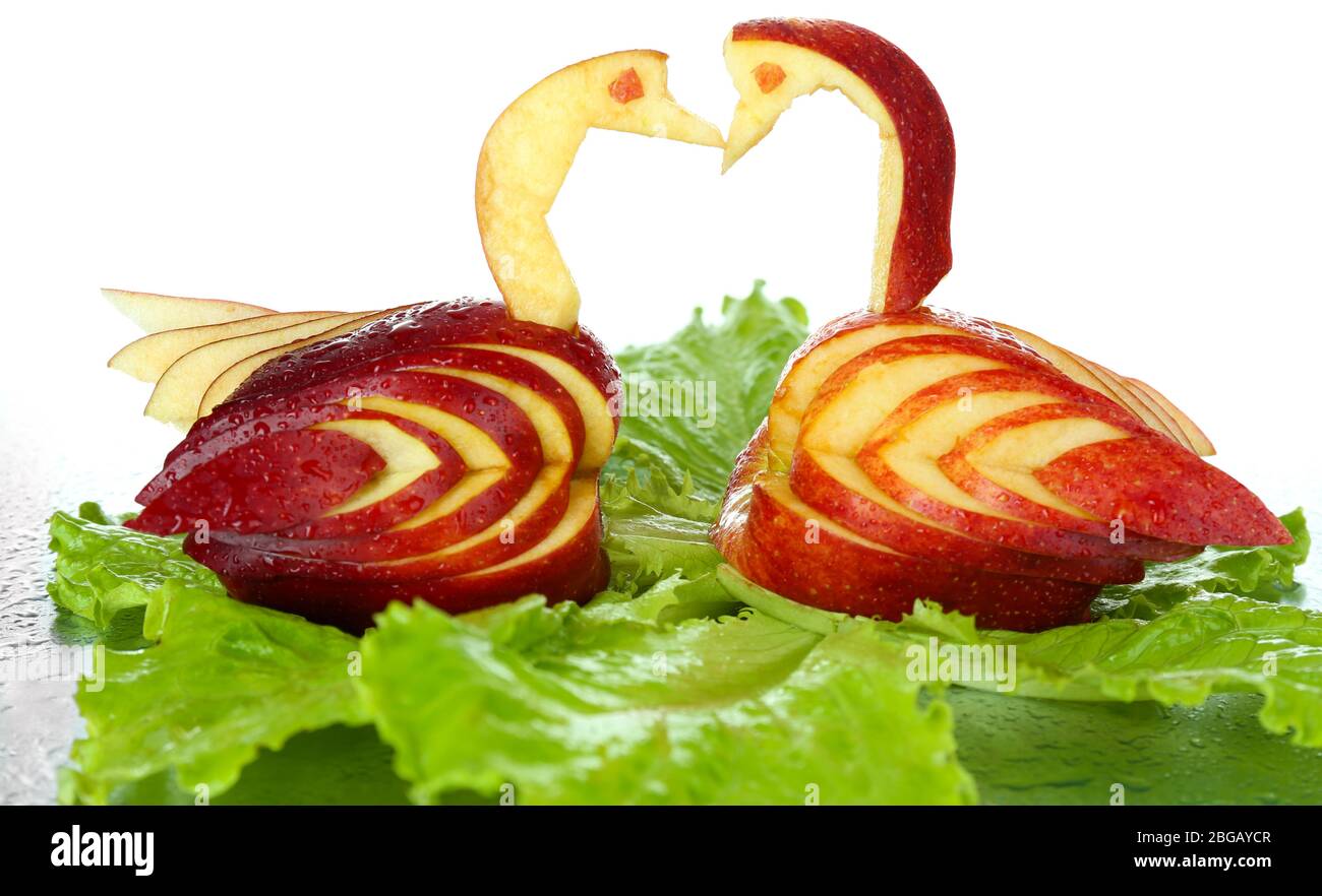 Carving fruit pattern of swan on grey wet background Stock Photo - Alamy