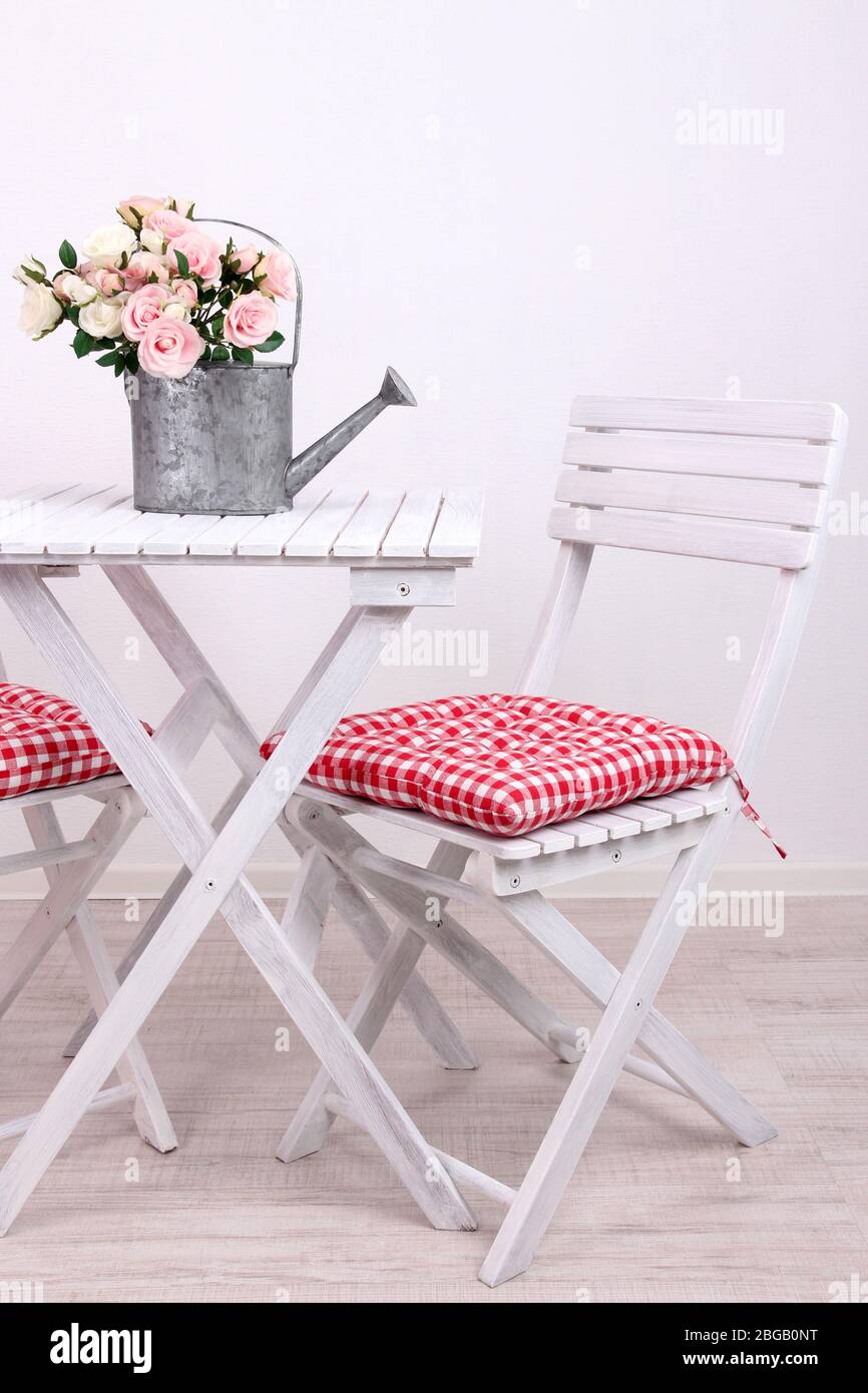 Garden chairs and table with flowers on white background Stock Photo ...