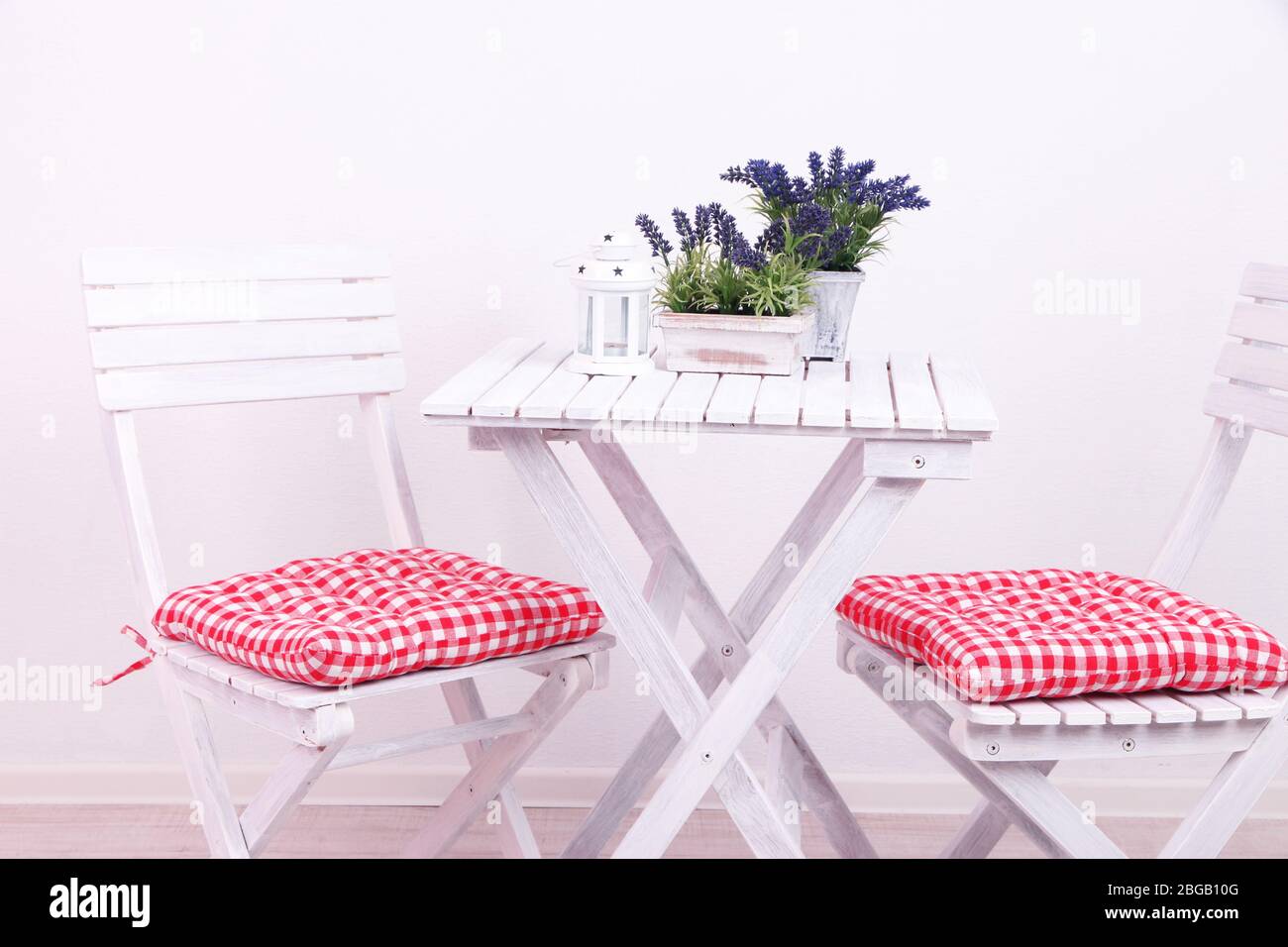 Garden chairs and table with flowers on white background Stock Photo ...