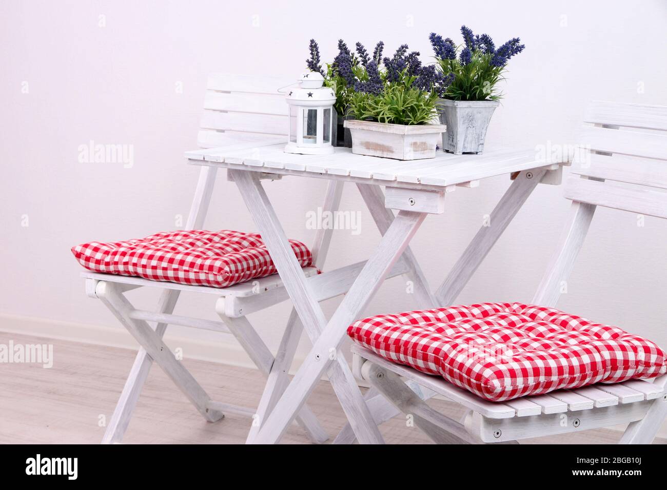 Garden chairs and table with flowers on white background Stock Photo ...