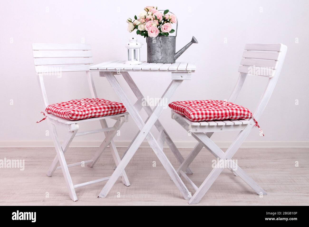 Garden chairs and table with flowers on white background Stock Photo ...