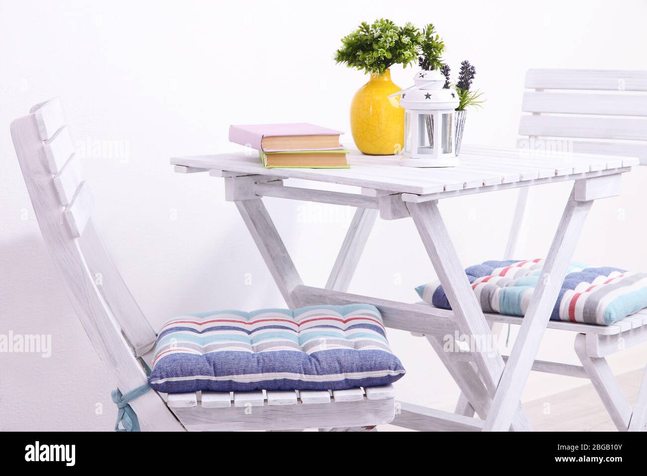 Garden chairs and table with flowers on white background Stock Photo ...