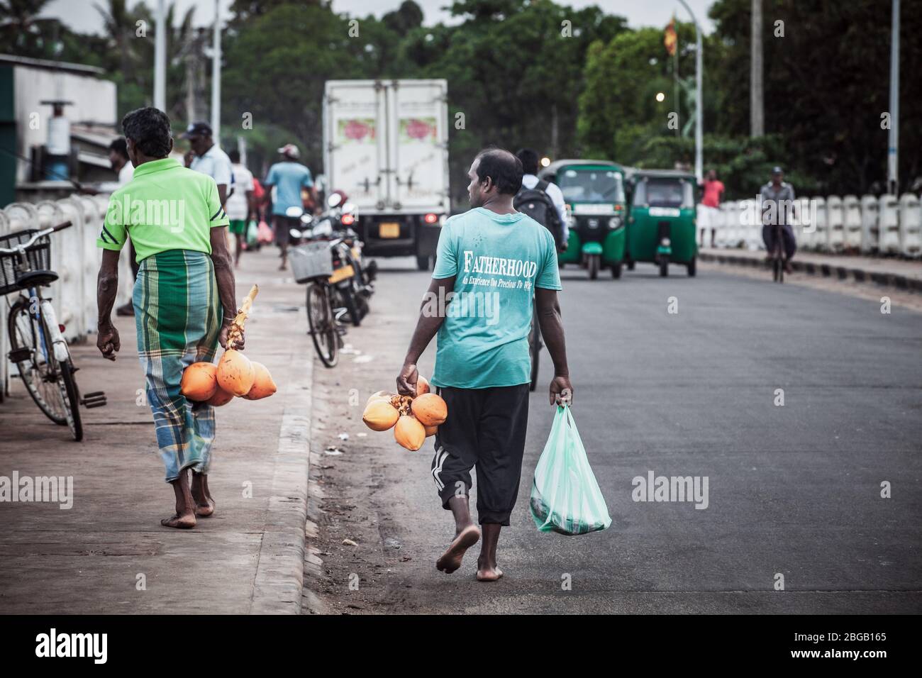 Negombo, Sri Lanka. July 20, 2016: Some people walking with recent ...