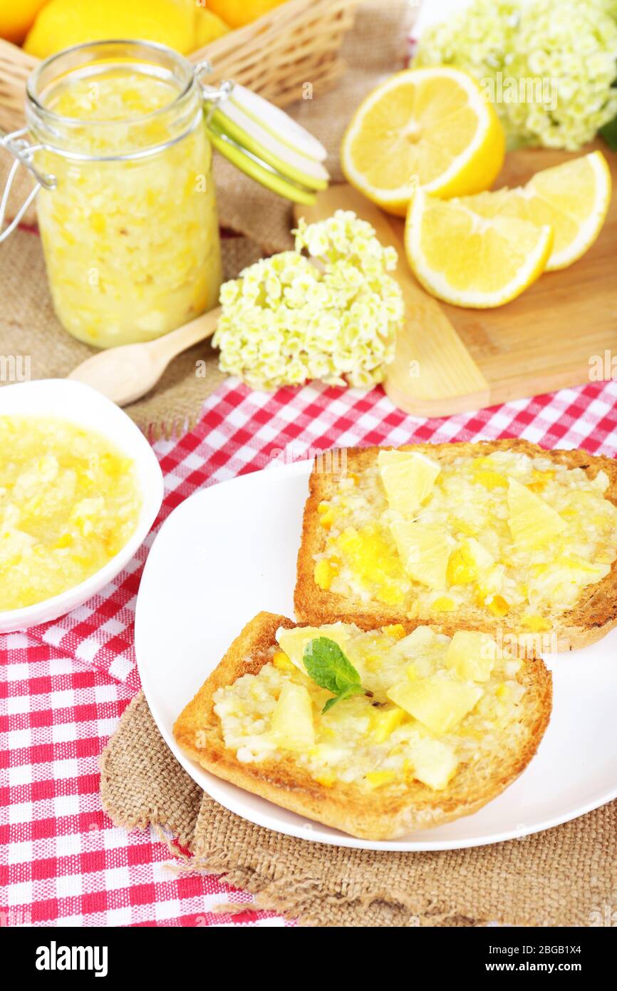 Delicious toasts with lemon jam on plate on table close-up Stock Photo ...