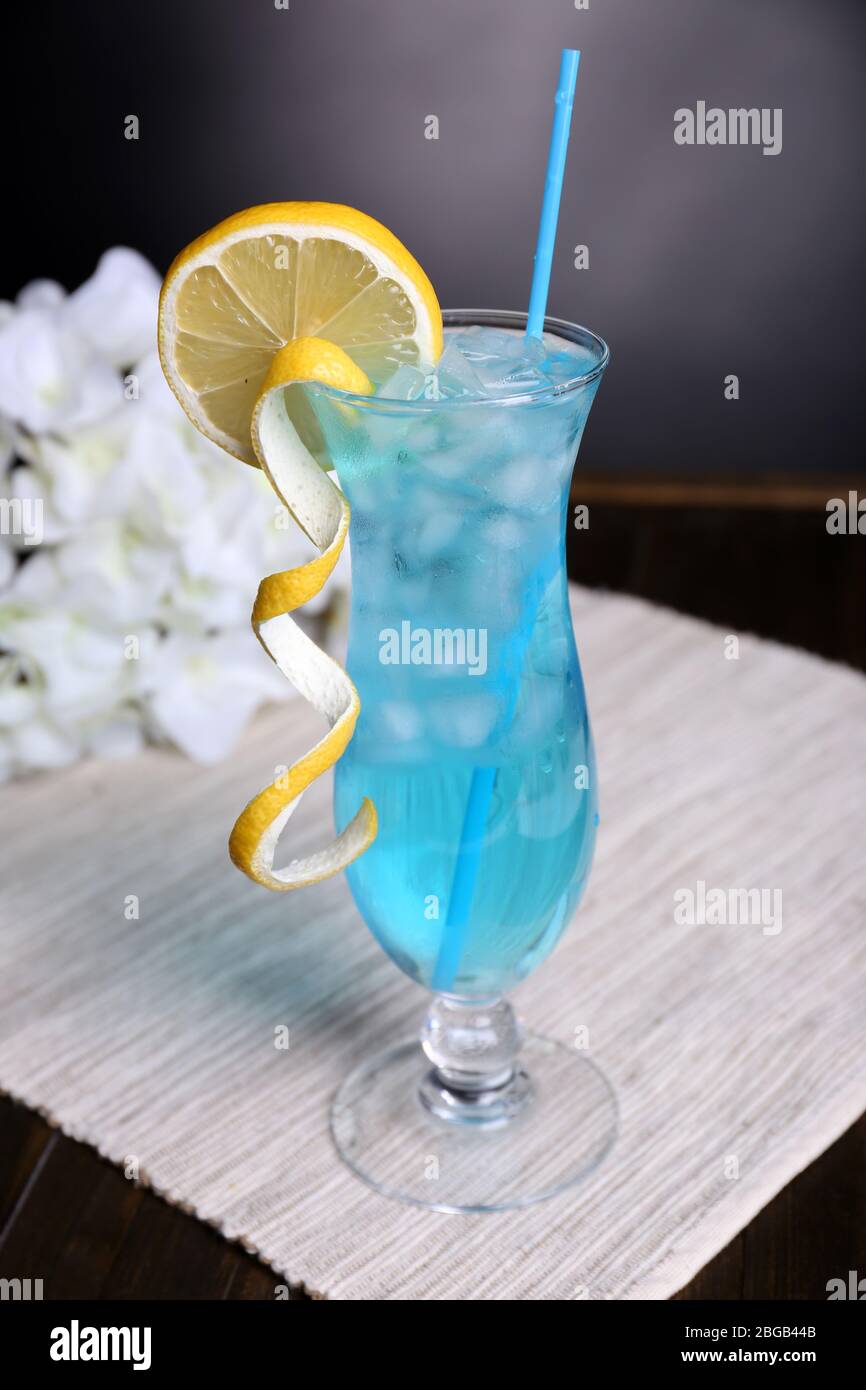 Glass of cocktail on table on grey background Stock Photo - Alamy