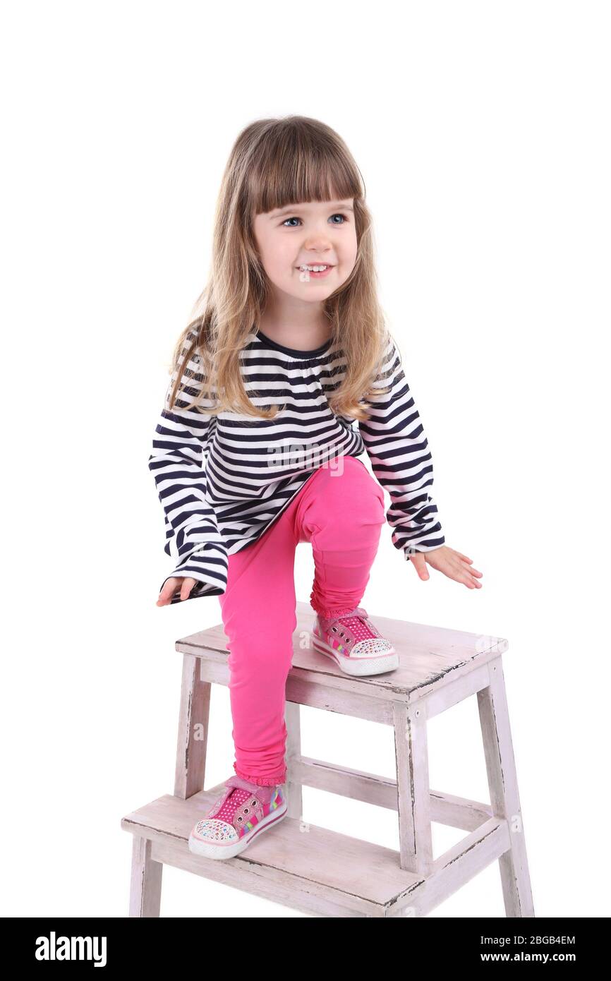 Pretty little girl sitting on small ladder isolated on white Stock ...