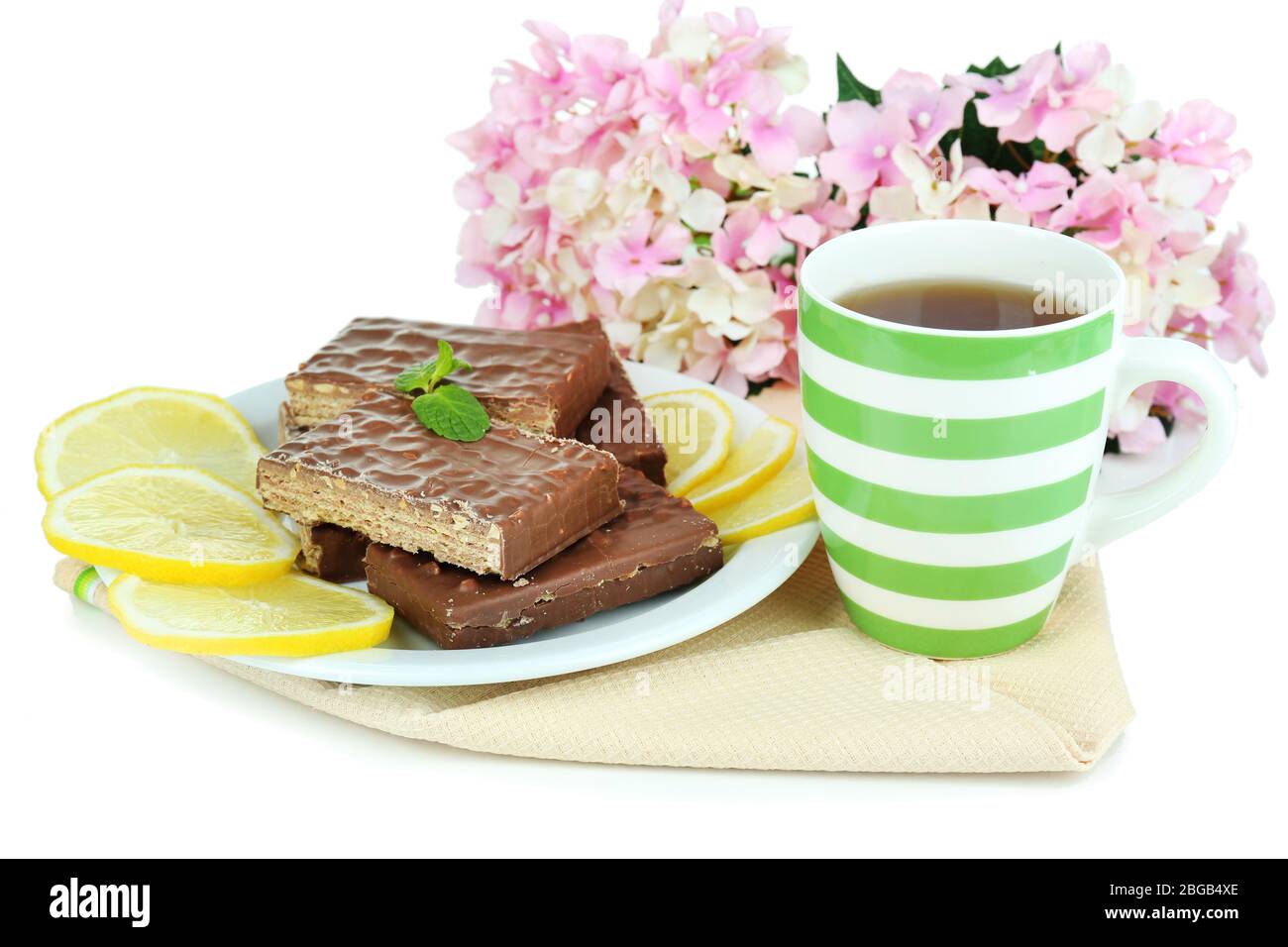 Cup of tea and sweets isolated on white Stock Photo - Alamy