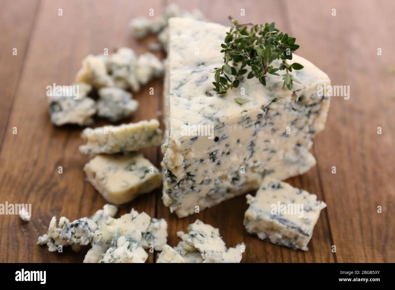 Tasty blue cheese with thyme, on wooden table Stock Photo - Alamy