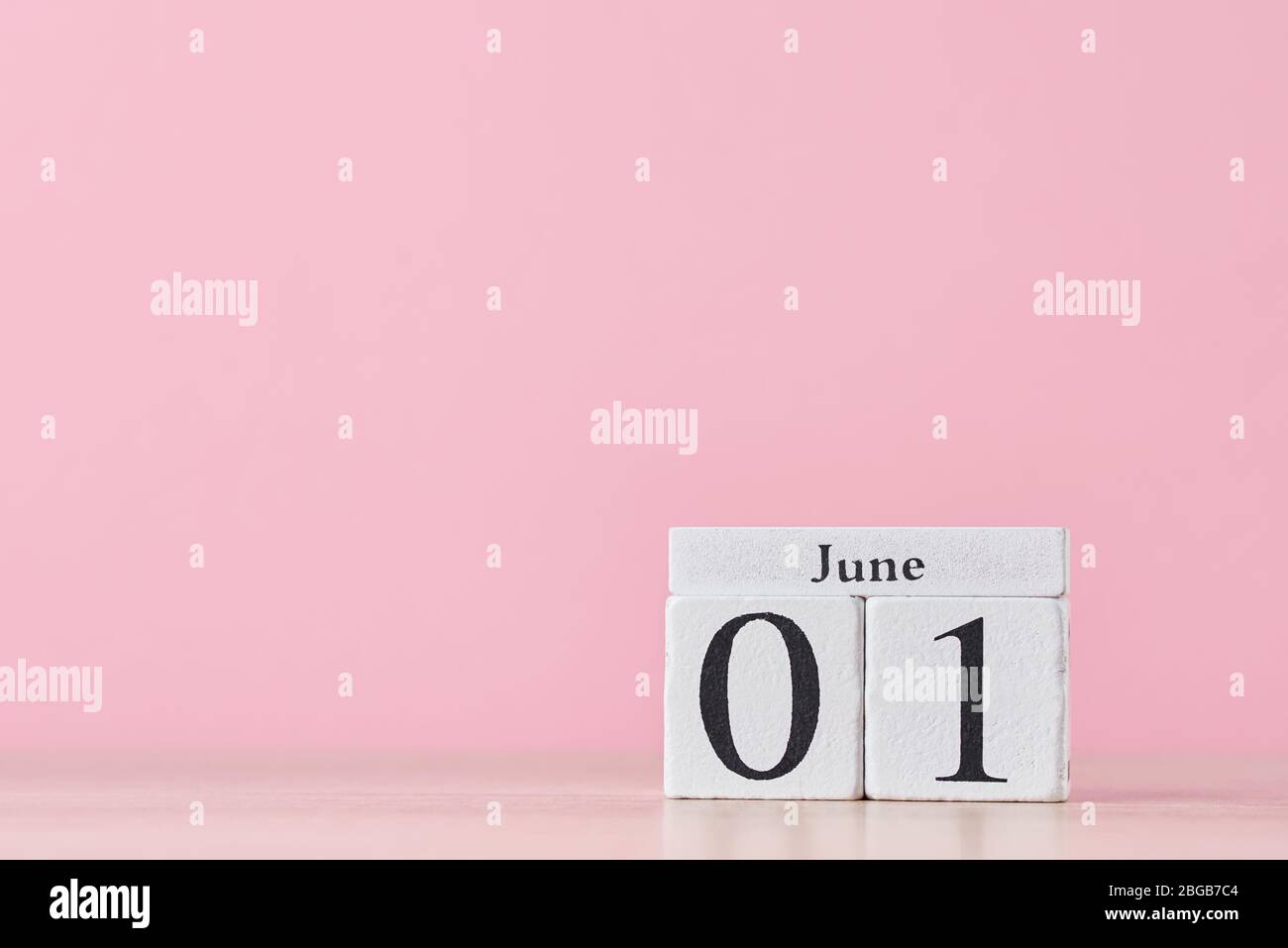 Wooden block calendar with date June 1 and succulent plant in pot on ...