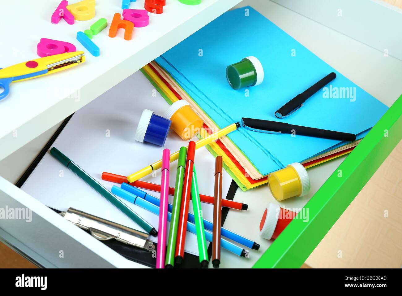 School supplies in open desk drawer close up Stock Photo - Alamy