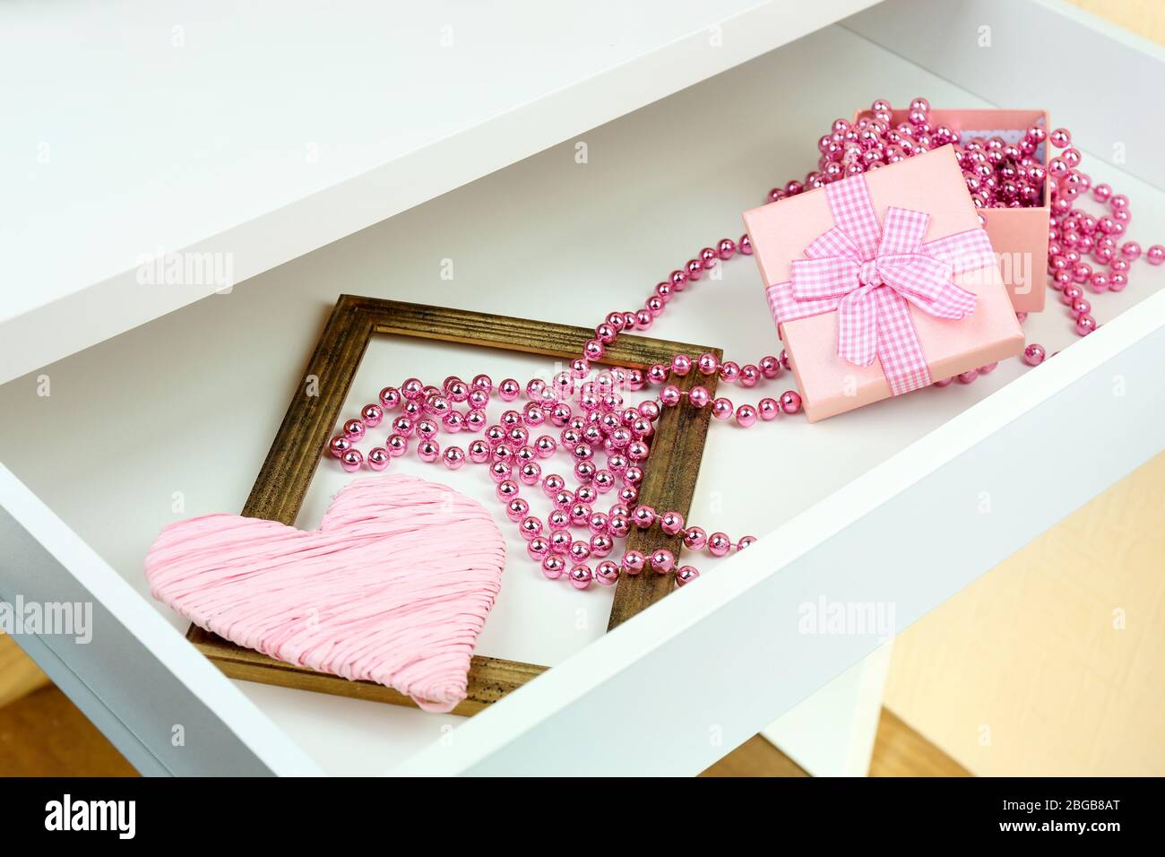 Gift box and beads in open desk drawer close up Stock Photo - Alamy