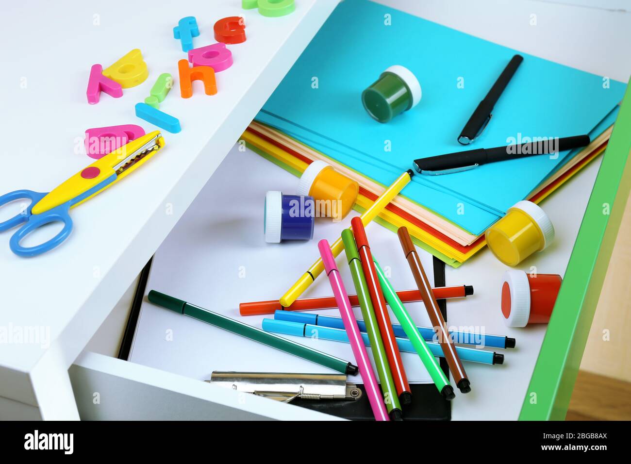 School supplies in open desk drawer close up Stock Photo - Alamy