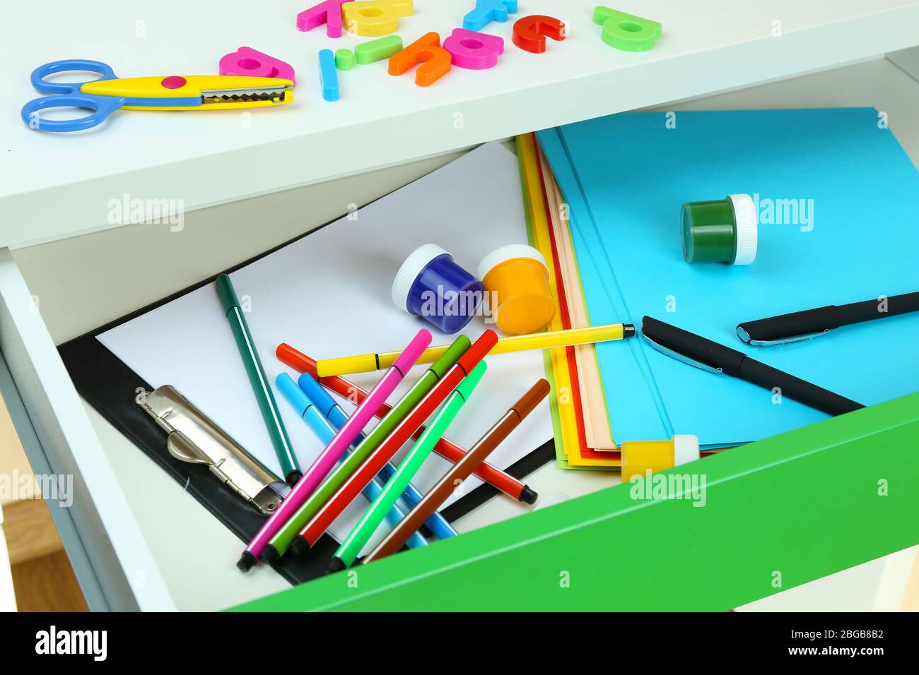 School supplies in open desk drawer close up Stock Photo - Alamy