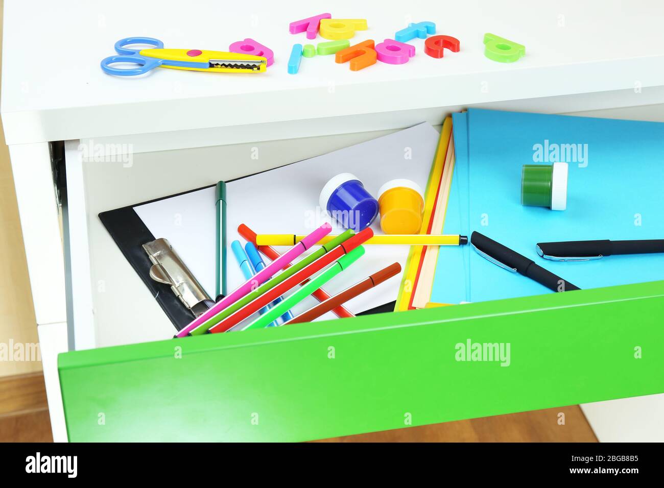 School supplies in open desk drawer close up Stock Photo - Alamy