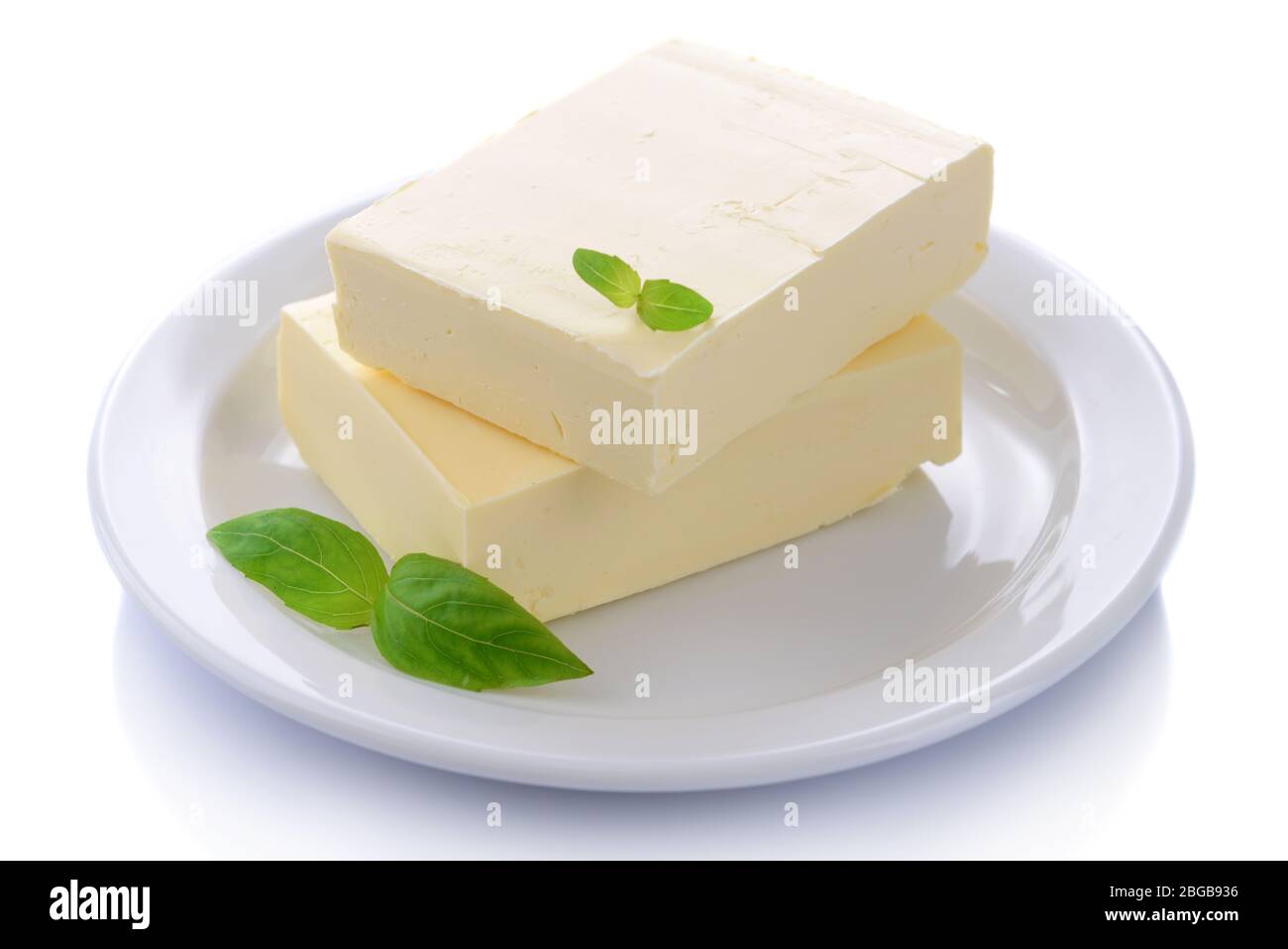 Tasty butter on plate isolated on white Stock Photo - Alamy