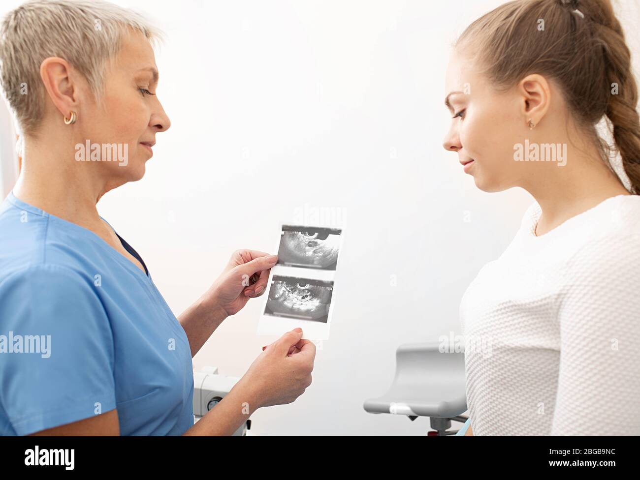 Gynecologist explaining to a patient a results of ovarian ultrasound ...