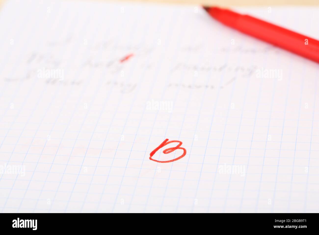 Grade written on an exam paper, close-up Stock Photo - Alamy