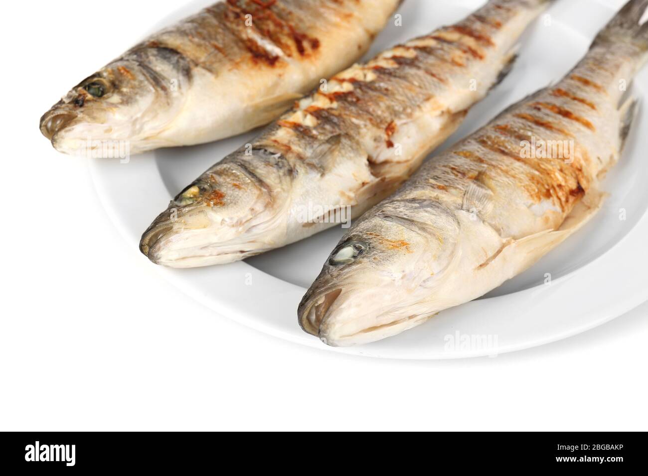 Delicious grilled fish on plate isolated on white Stock Photo - Alamy