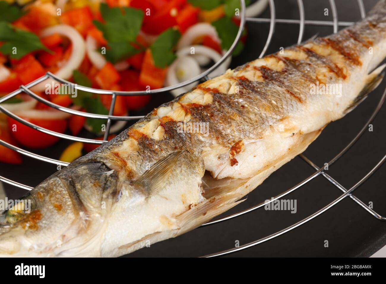Delicious grilled fish on wok close-up Stock Photo - Alamy