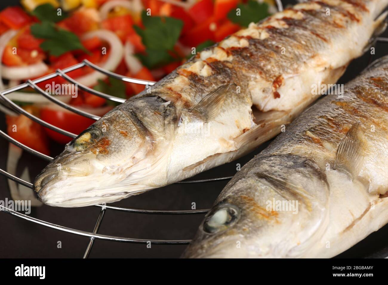 Delicious grilled fish on wok close-up Stock Photo - Alamy