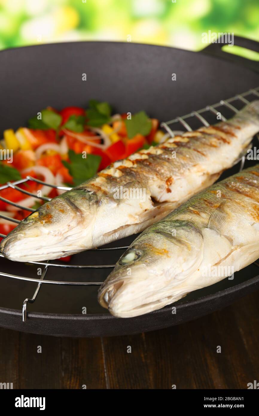 Delicious grilled fish on wok close-up Stock Photo - Alamy