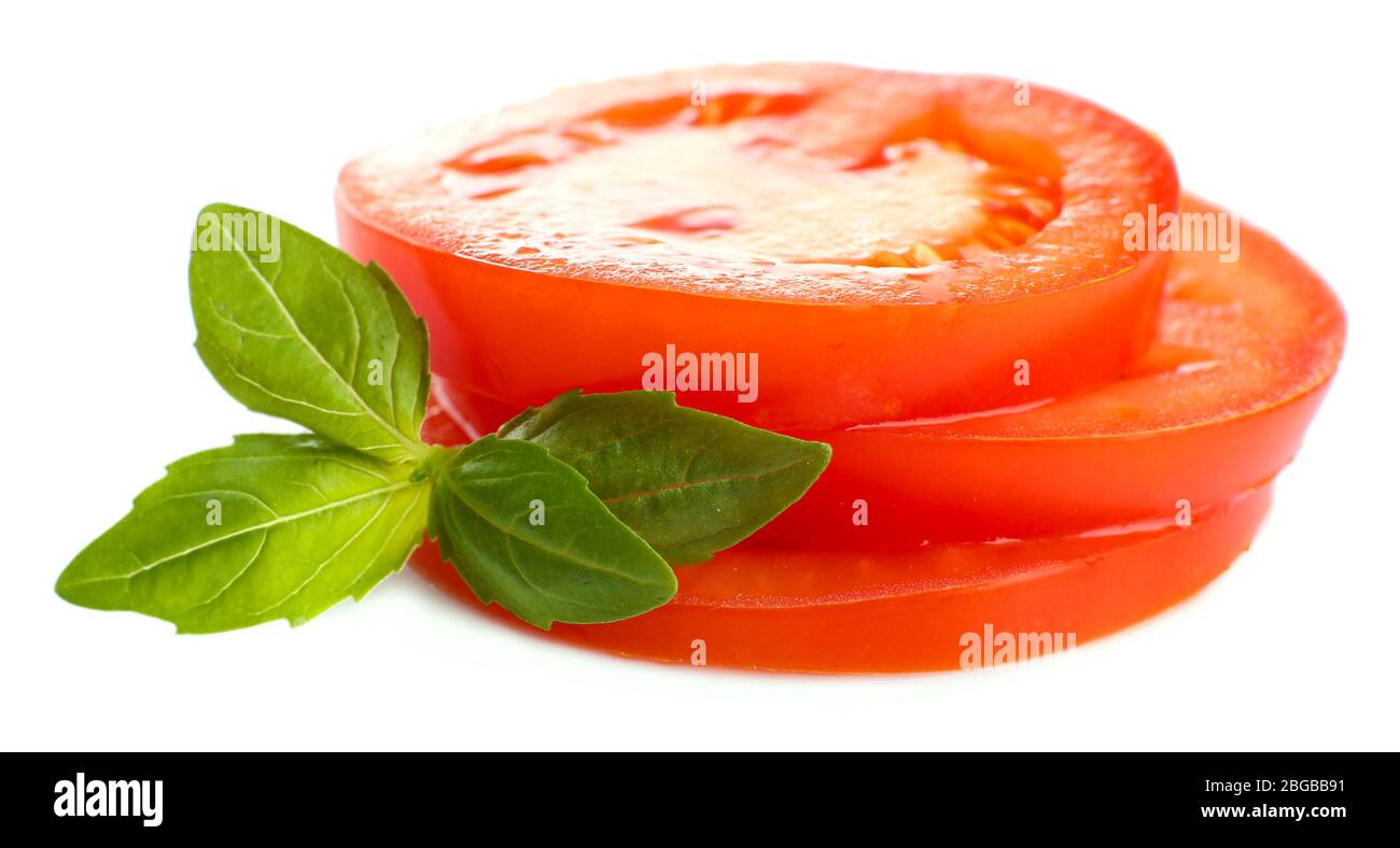 Slices of fresh tomato with basil, isolated on white Stock Photo - Alamy