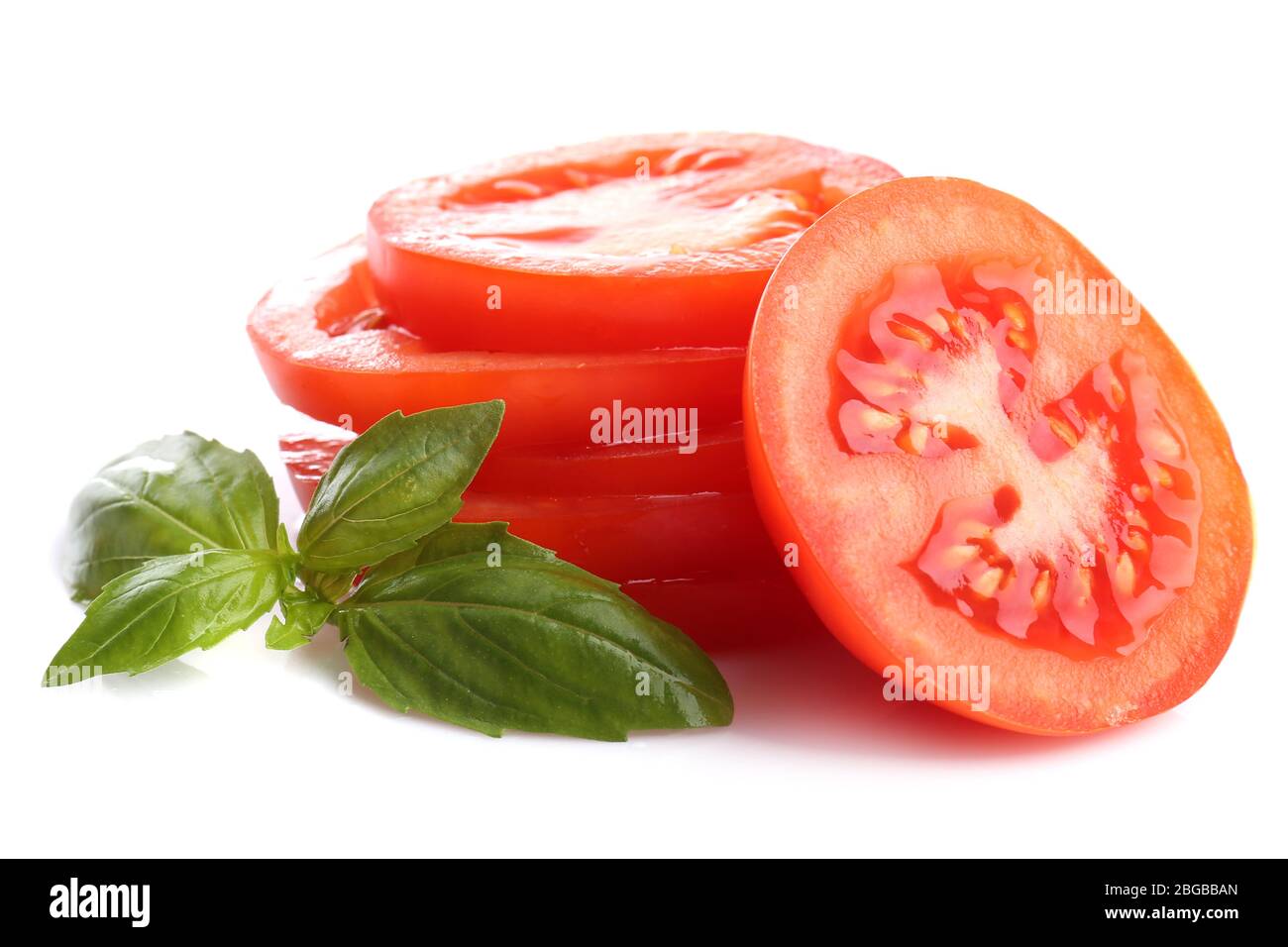 Slices of fresh tomato with basil, isolated on white Stock Photo - Alamy