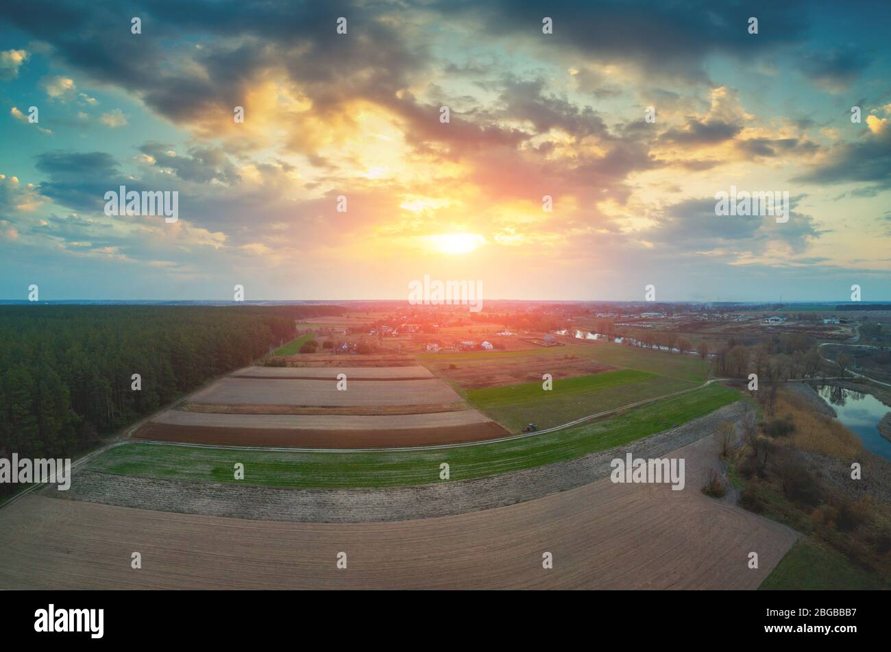 Sunset in the countryside. Rural landscape in early spring. Aerial view ...