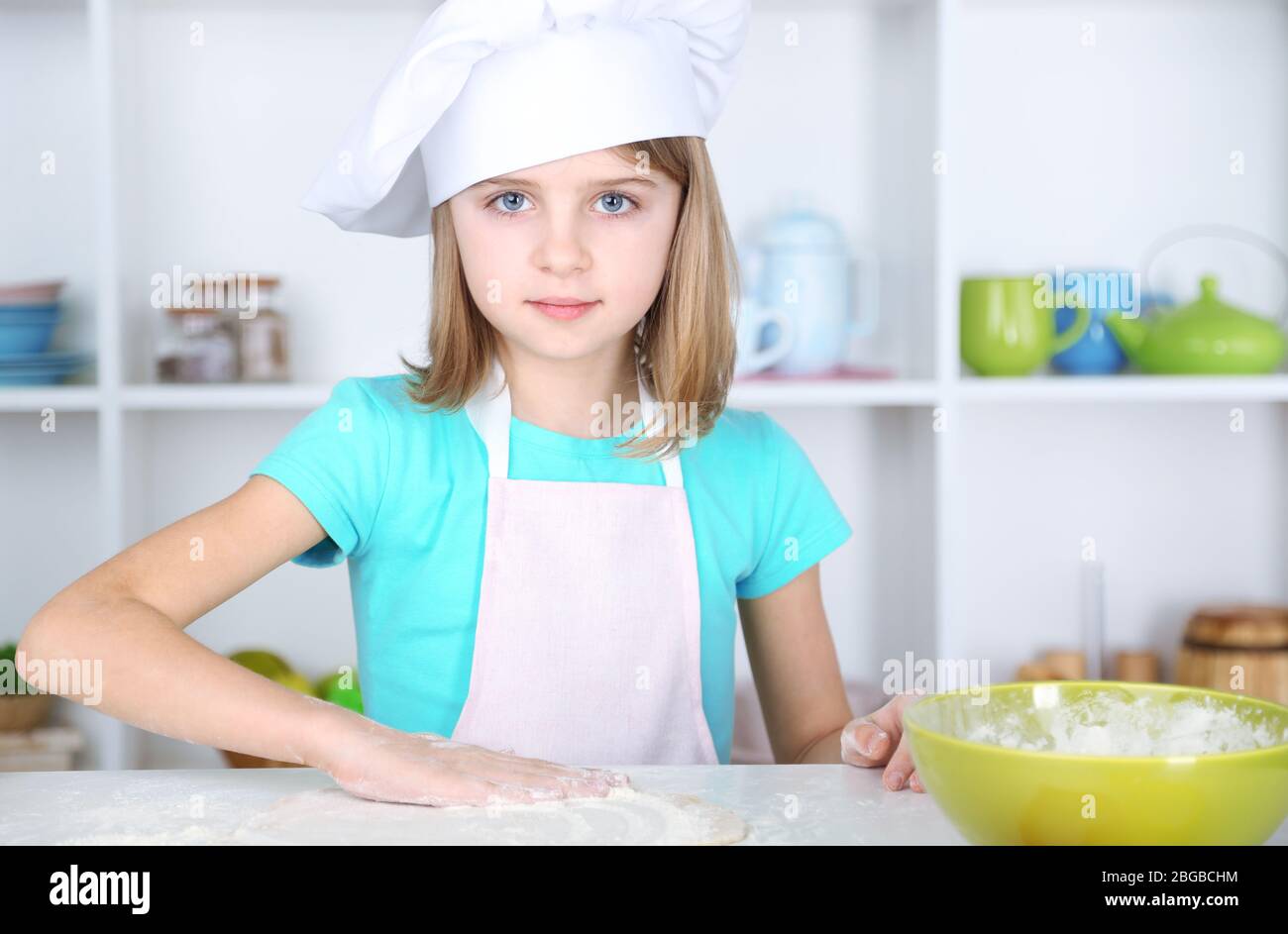 Little girl preparing cake dough in kitchen at home Stock Photo - Alamy