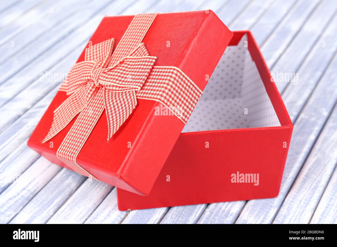 Open gift box on wooden background Stock Photo - Alamy