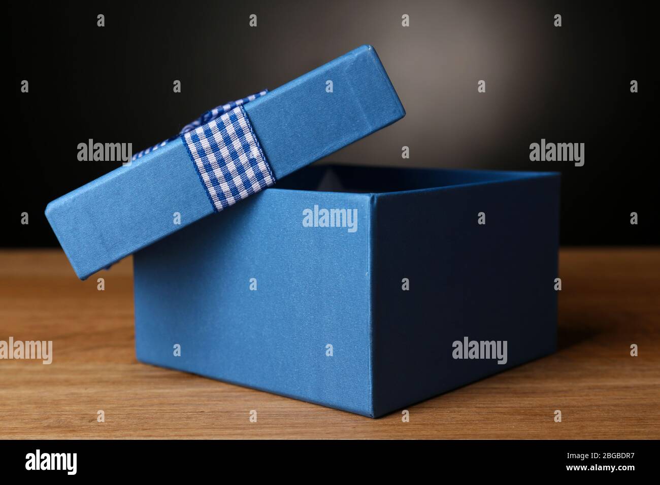 Open gift box on dark background Stock Photo - Alamy