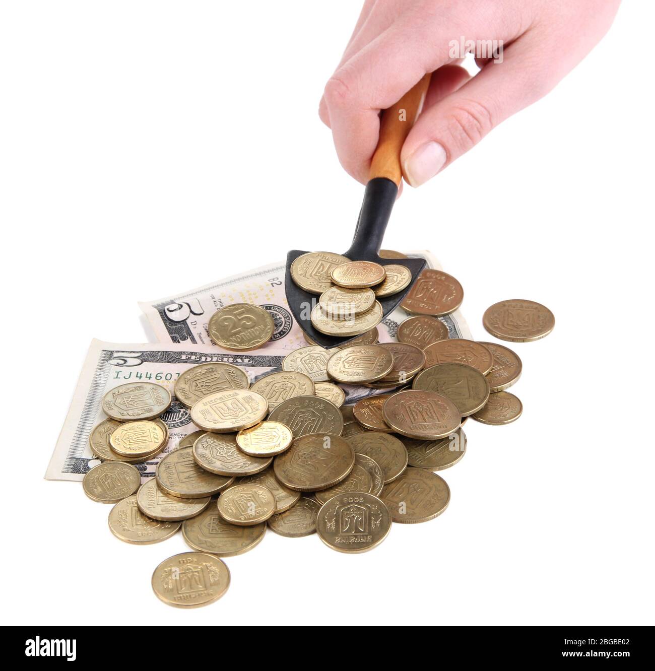 Hand holding shovel with coins isolated on white Stock Photo - Alamy