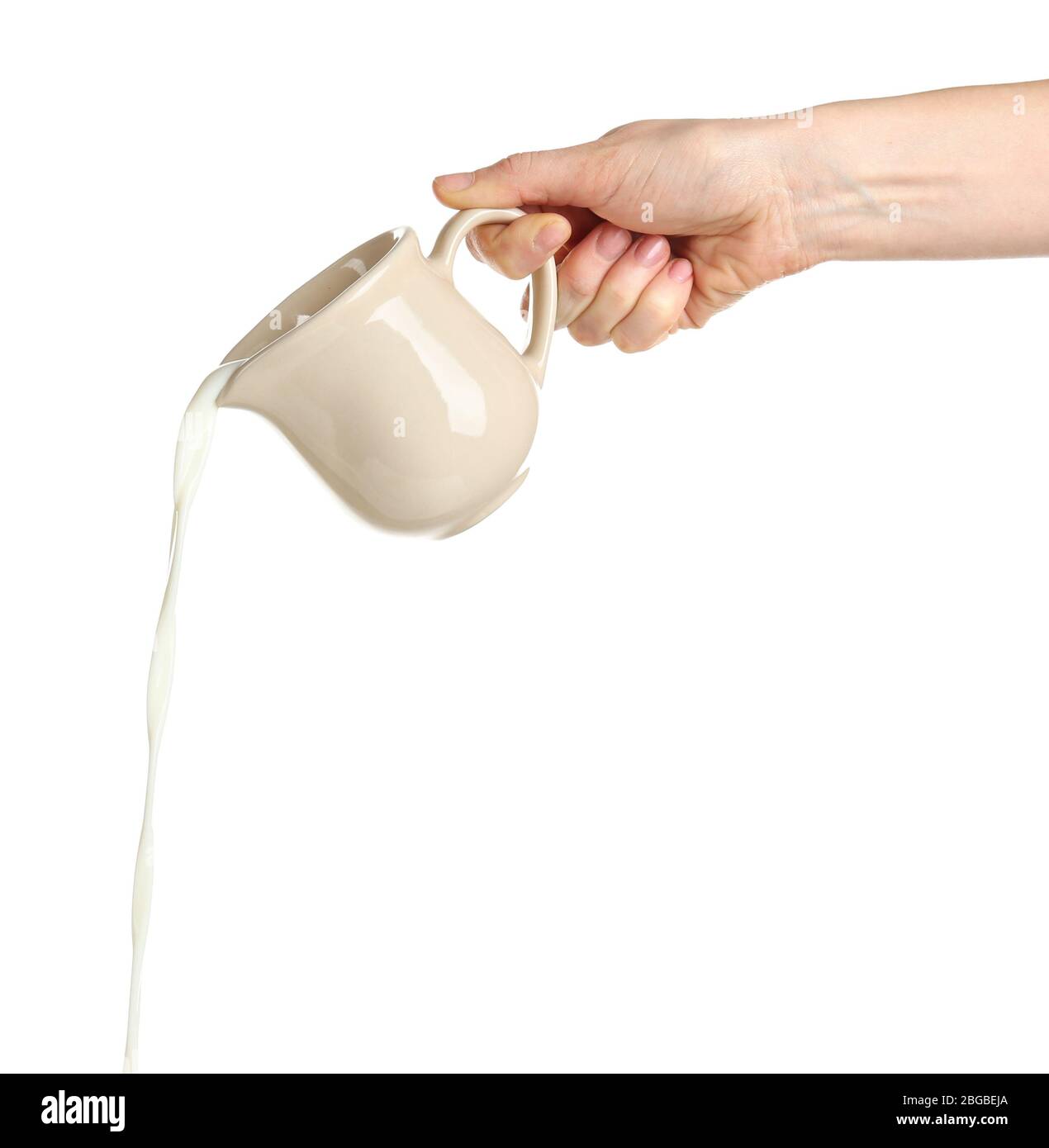 Pouring milk from pitcher, isolated on white Stock Photo - Alamy