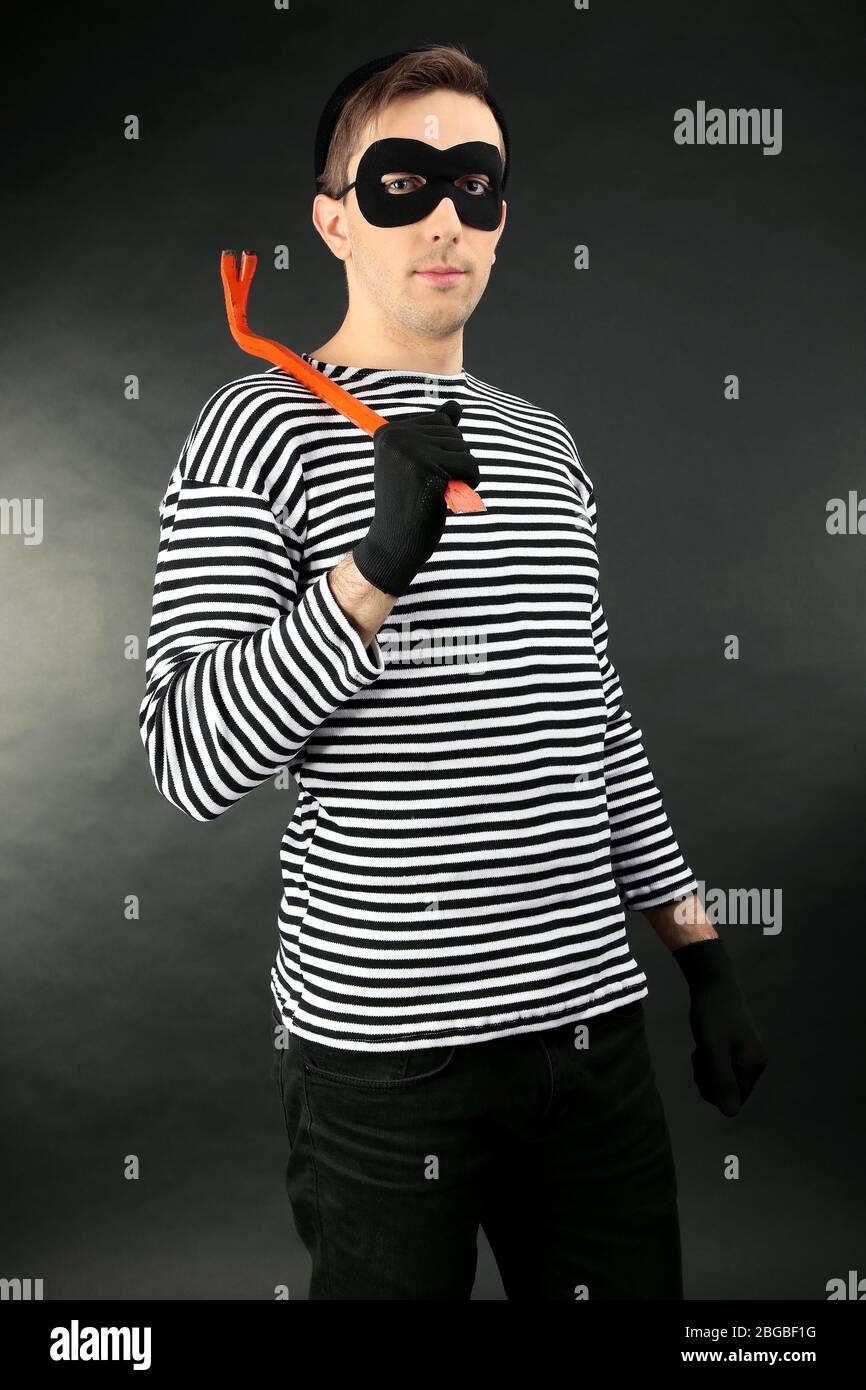 Thief on dark background Stock Photo - Alamy