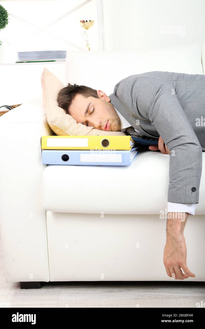 Elegant businessman sleeping on sofa hi-res stock photography and ...