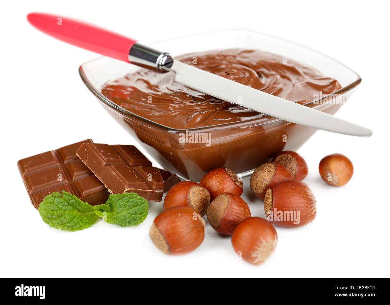 Sweet chocolate hazelnut spread with whole nuts and mint isolated on ...