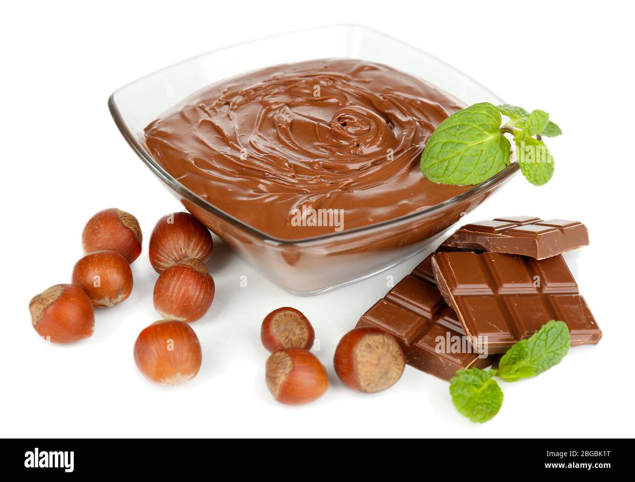Sweet chocolate hazelnut spread with whole nuts and mint isolated on ...