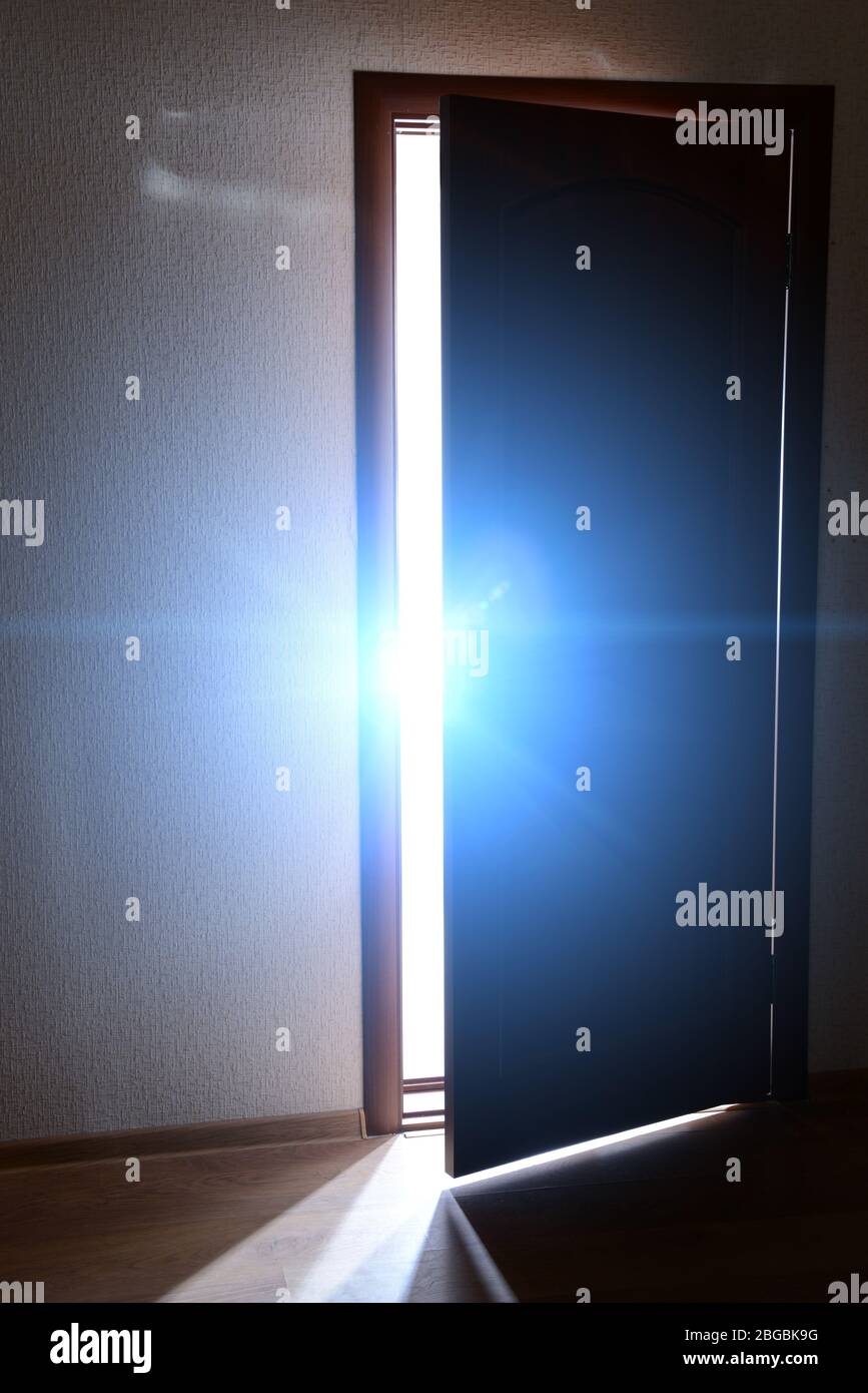 Open door with bright light outside Stock Photo - Alamy