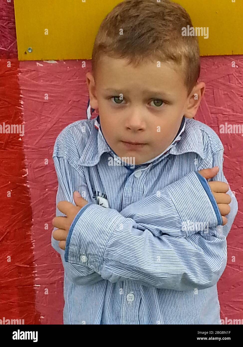 Little boy is afraid of red wall Stock Photo - Alamy