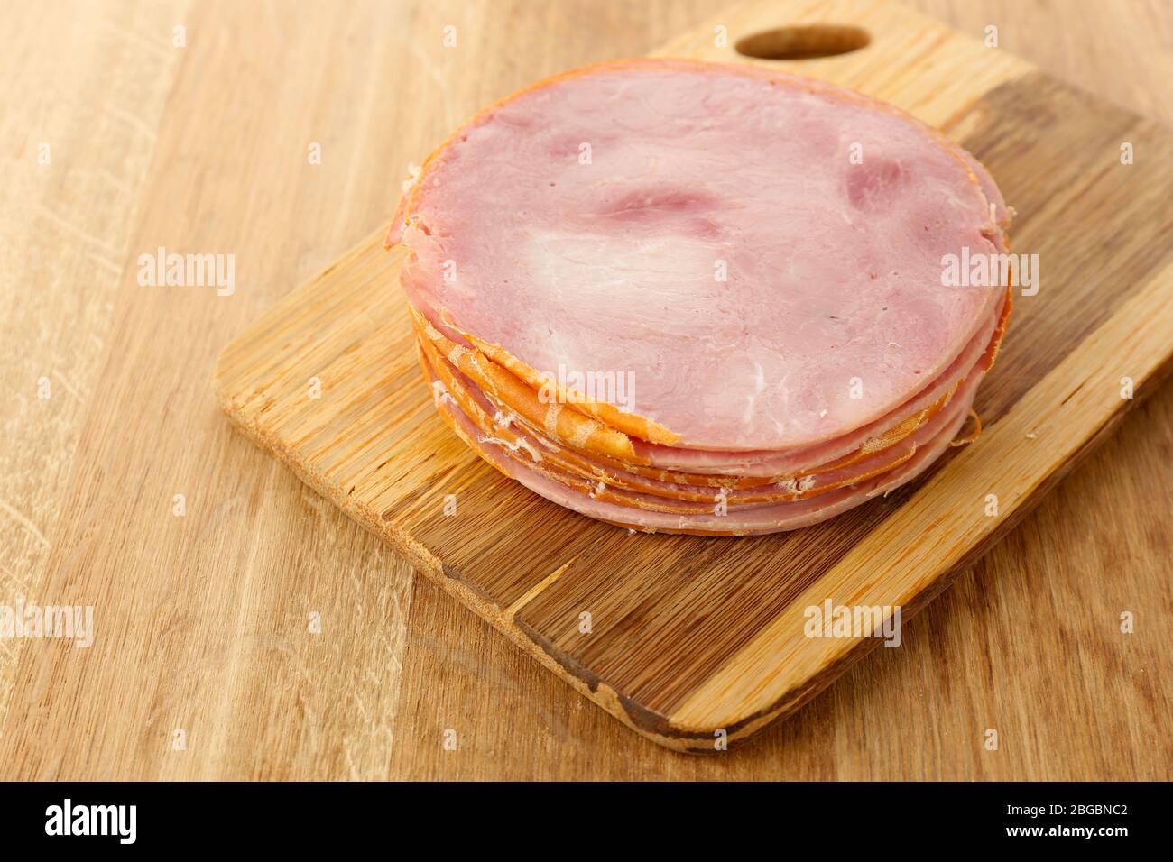 Tasty ham on wooden background Stock Photo - Alamy