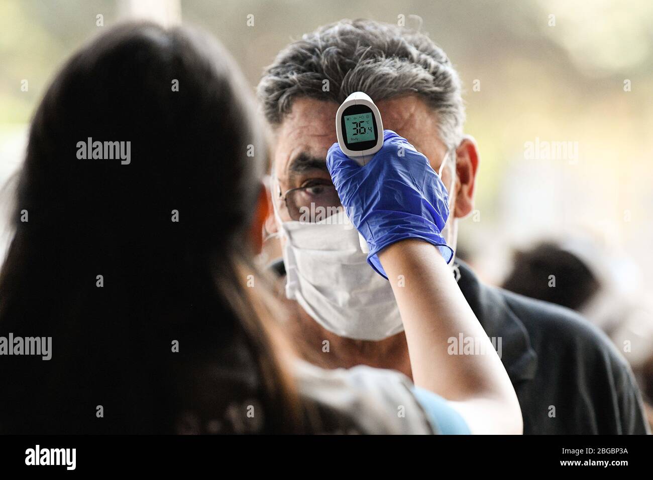 Man gets temperature checked hi-res stock photography and images - Alamy