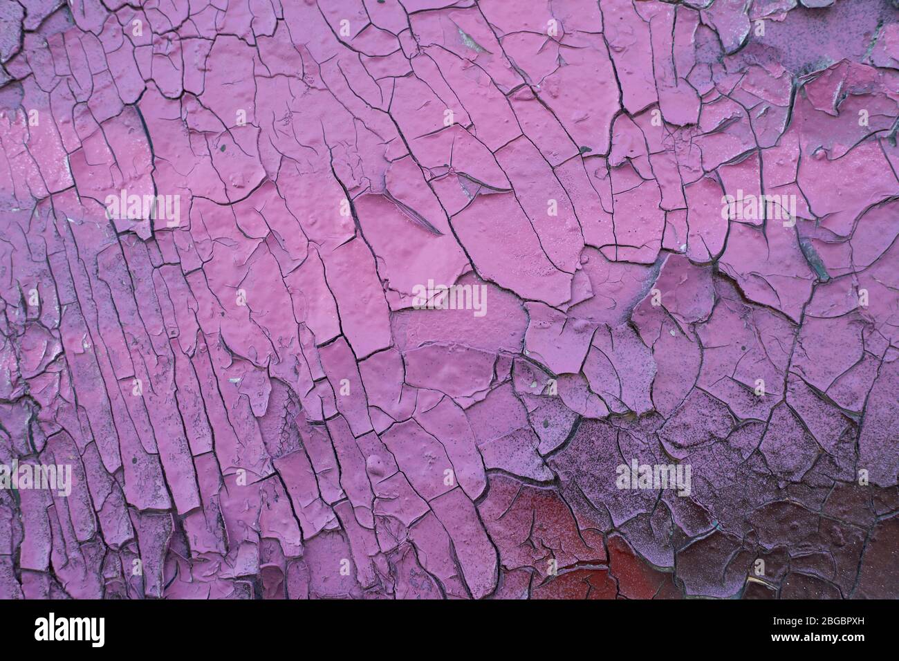 The texture of the old painted wall is covered with cracks and ...
