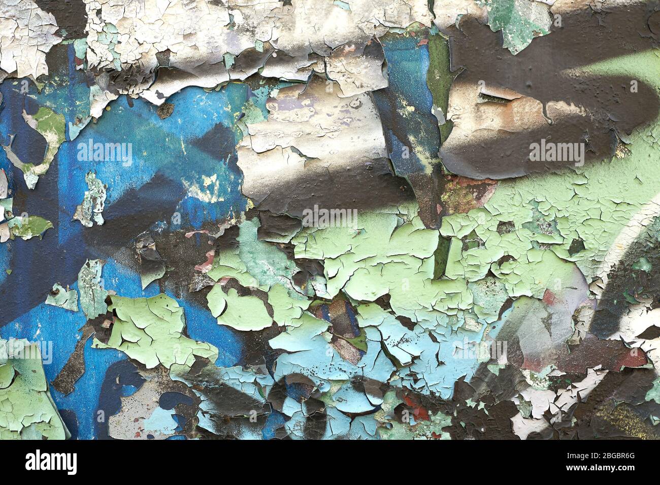 The texture of the old painted wall is covered with cracks and ...