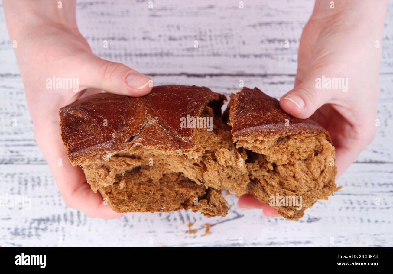 Breaking Bread Hands High Resolution Stock Photography and Images - Alamy
