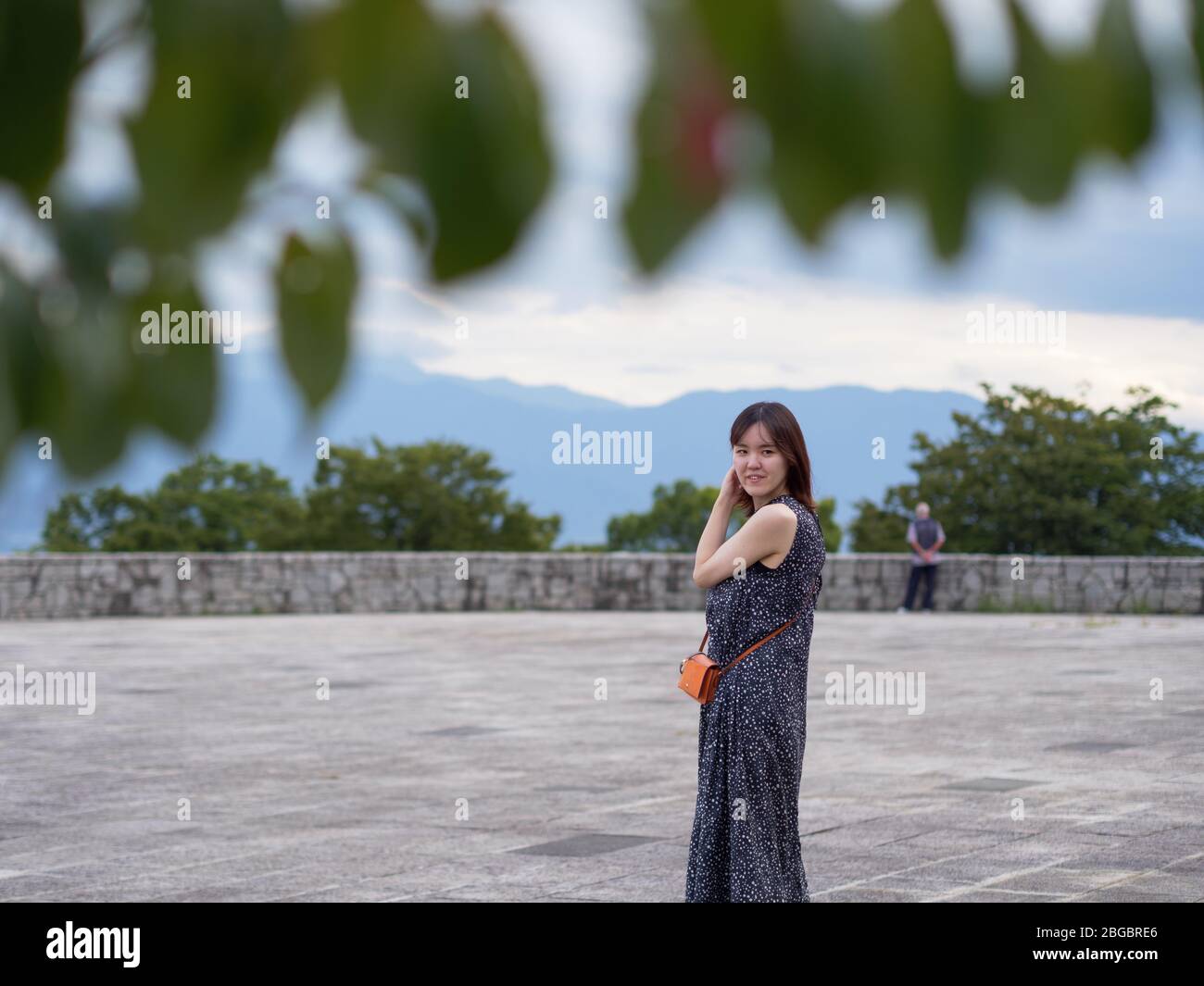 A beautiful woman looking back at the camera and smiling Stock Photo ...