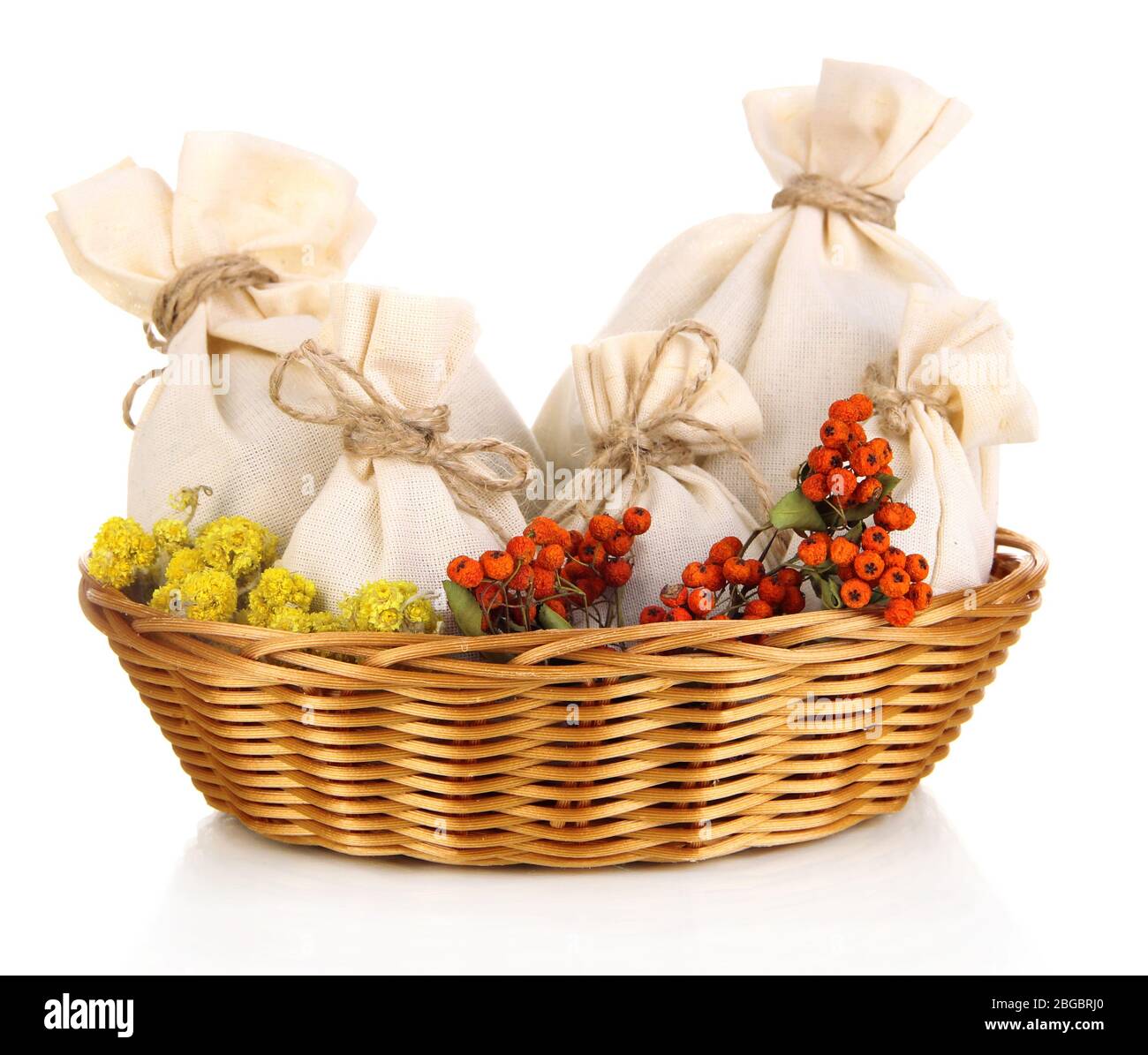 Textile sachet pouches with dried flowers, herbs and berries in wicker ...