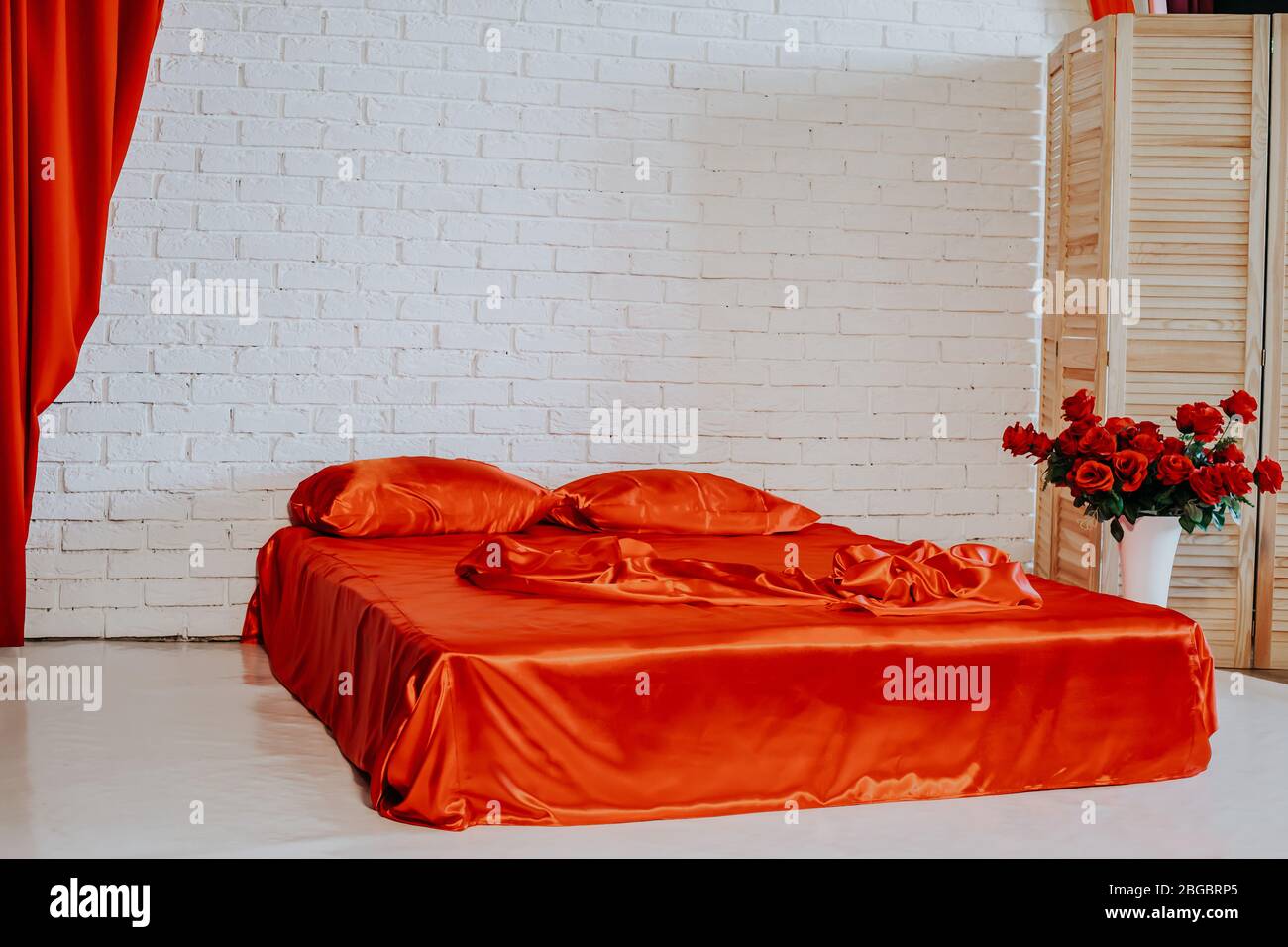 red bed in the bedroom interior of the white room Stock Photo - Alamy