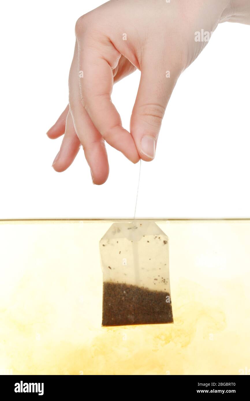 Tea bag dipped in hot water Stock Photo - Alamy